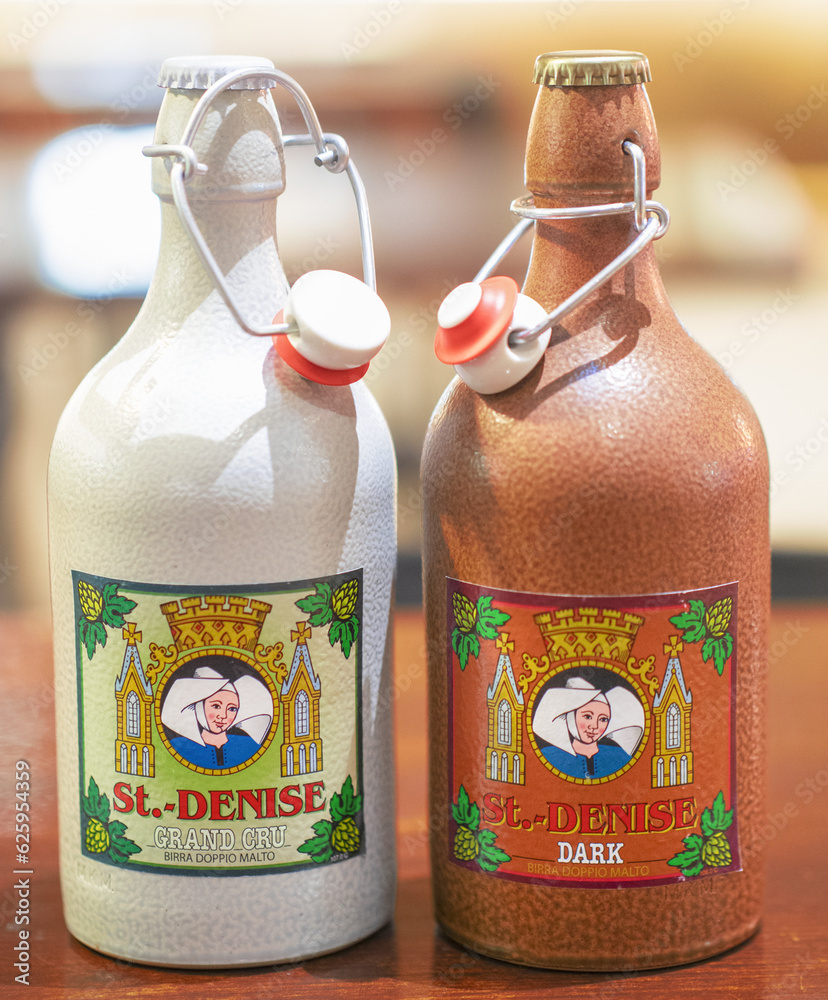 bottles of golden and dark Belgian craft beer St Denise.Milan - Italy ...