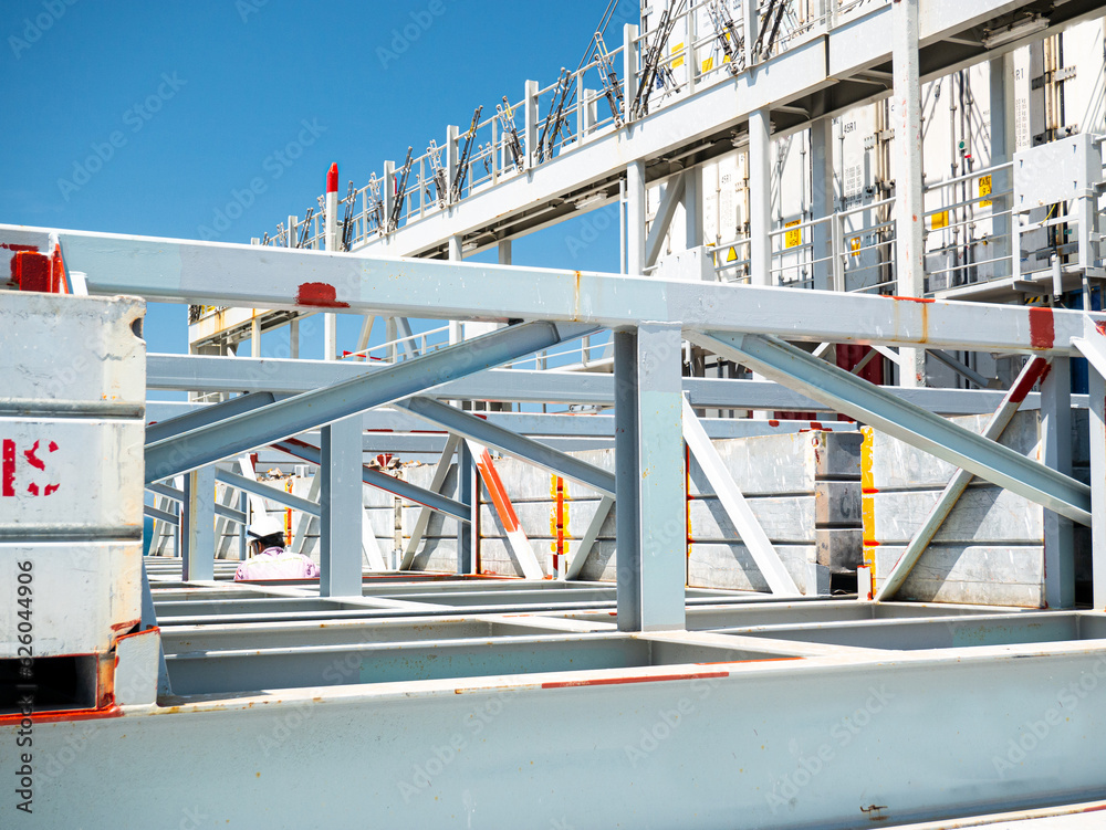 Crew member seaman in boiler suit and safety helmet painting metal ...