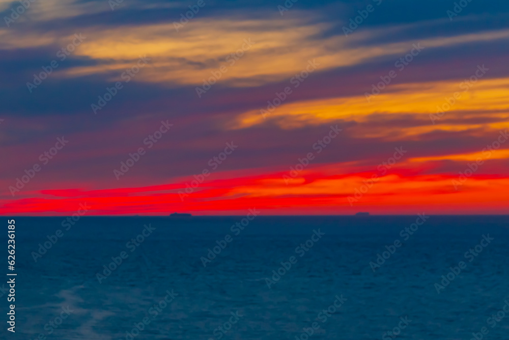 Panoramic view of the ocean sunset against the background of multi ...