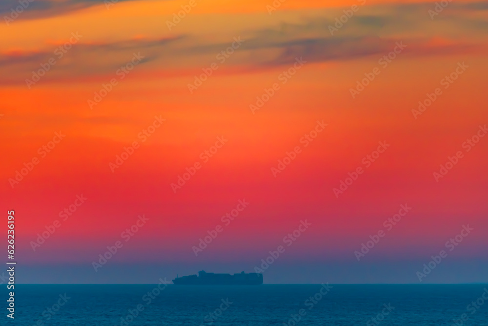 Panoramic view of the ocean sunset against the background of multi ...