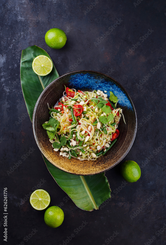 Traditional Thai green papaya som tam salad with green papaya slices ...