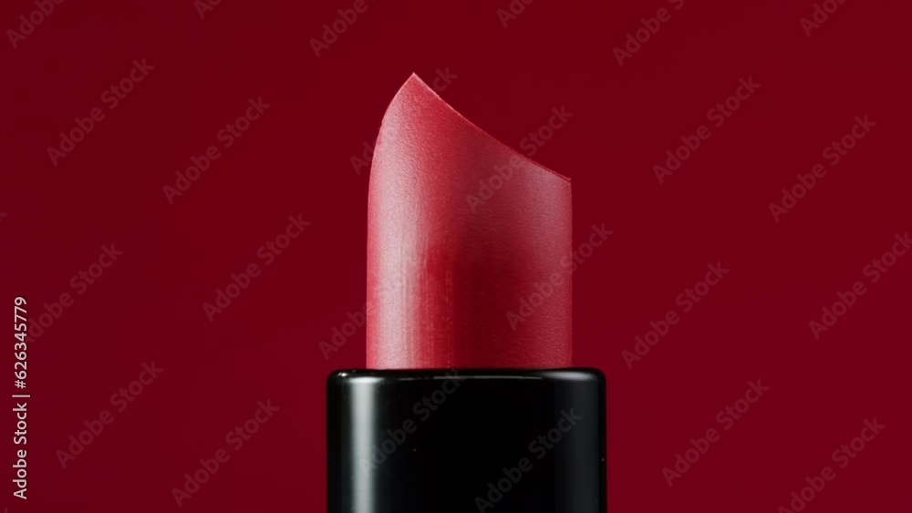 Red lipsticks make up close up background with smoke and water drops ...