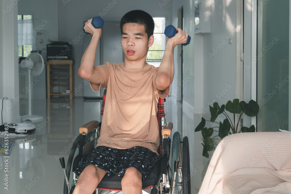 Asian young man holding dumbbell for exercise his muscle indoor at home ...