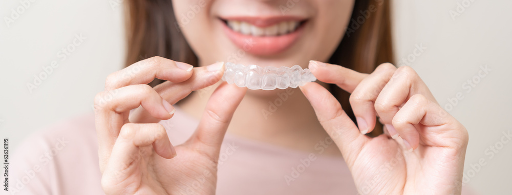 Dental invisible braces, beautiful smiling asian young woman holding ...