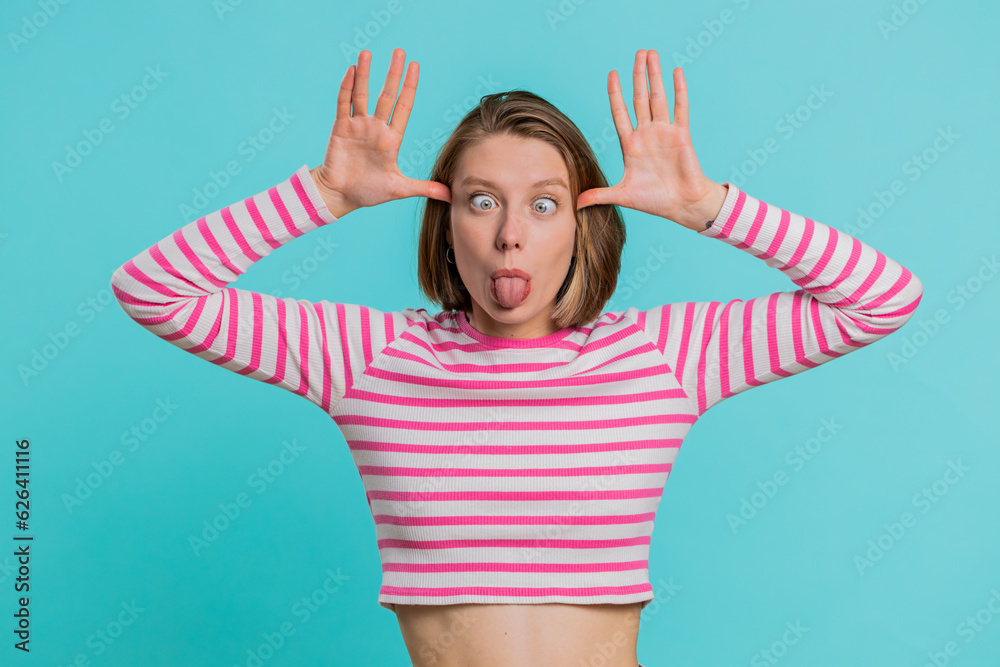 Funny comical playful young woman making silly facial expressions and ...