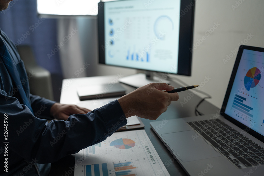 Businessman analyzing financial data statistics on pc computer pointing ...
