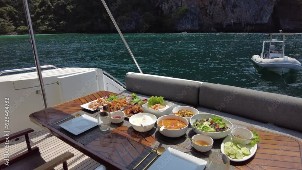 Dining table set for guests of a private motor yacht, Thai cuisine ...