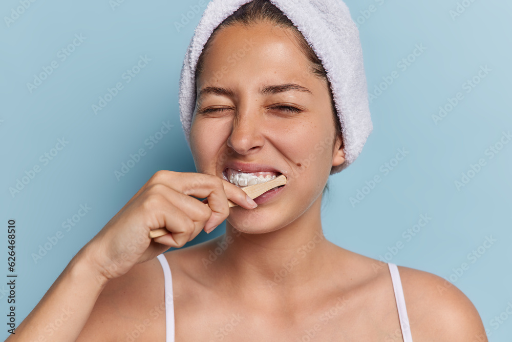 Horizontal shot of young European woman poses with white bath towel ...