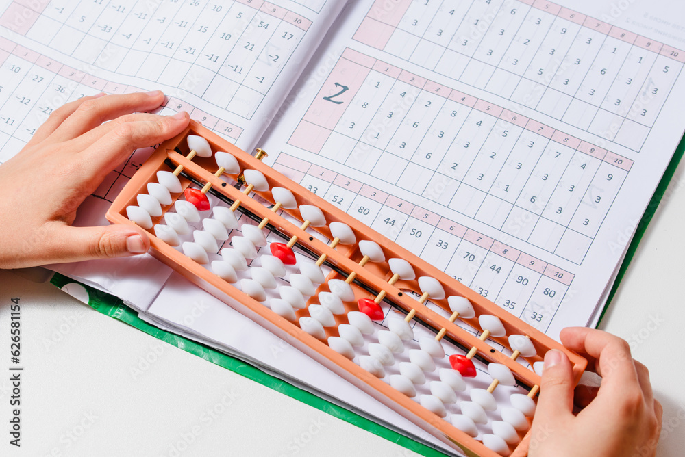 Japanese traditional abacus soroban isolated on white background. Child Hand using abacus ...