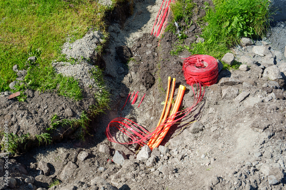 fiber optic cables been installed underground in dug trenches front of ...