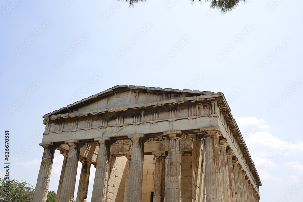 Old ancient restored Greek building with columns and roof in ancient ...
