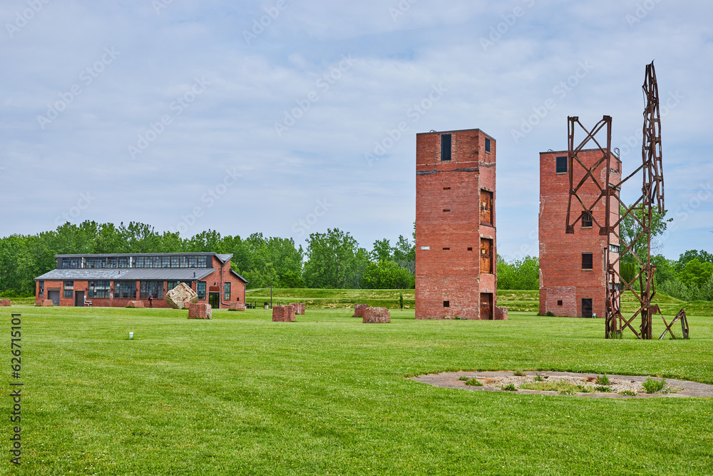 Rusty tower in front of destroyed factory with freight elevators and ...