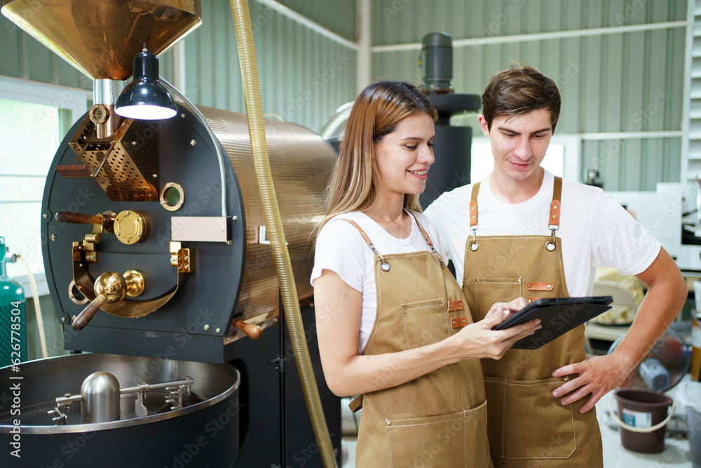 Professional male and female coffee roasters working with modern ...