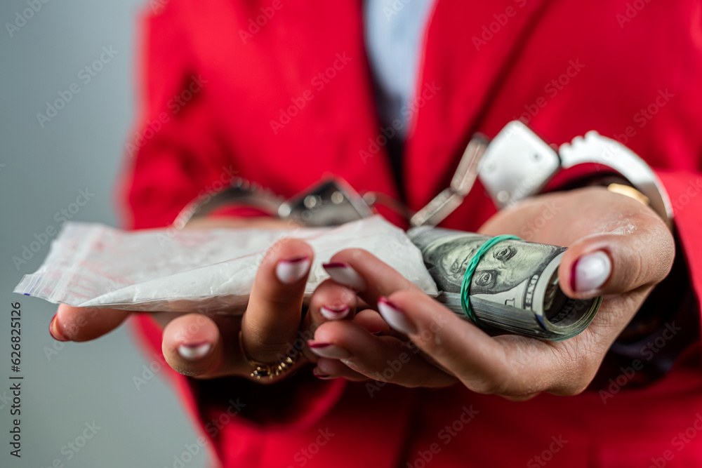 man in handcuffs with money and white powder in a bag in his hands ...