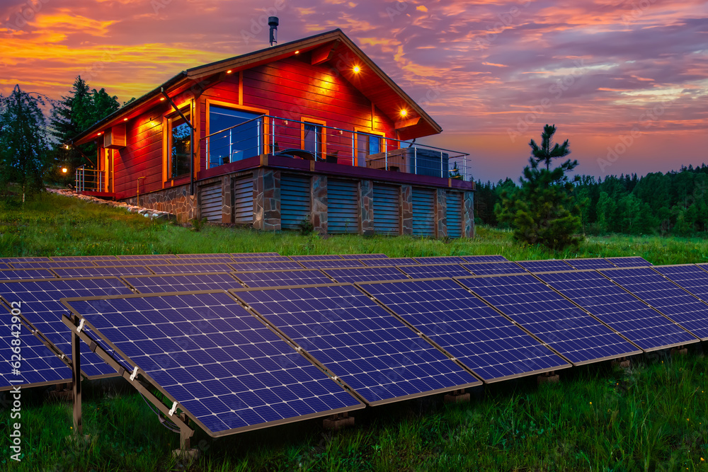 Solar electric farm. House behind photovoltaic panels. Power plant near ...
