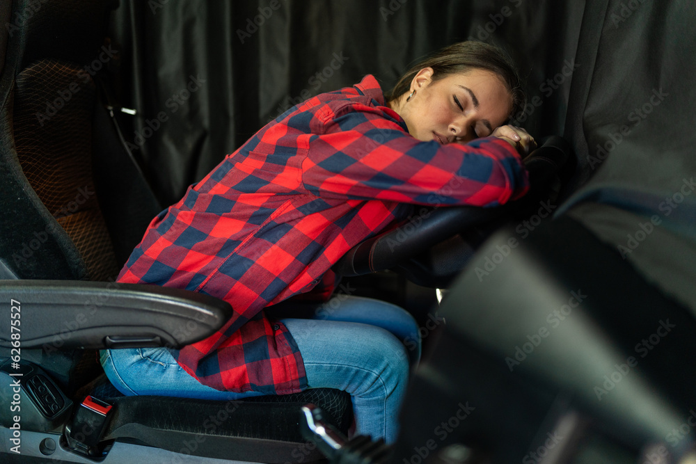young girl professional truck driver sleeping in the lorry cabin on the ...