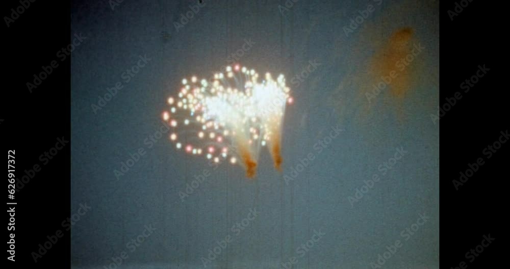 People crowd watching fireworks on city buildings background at night ...