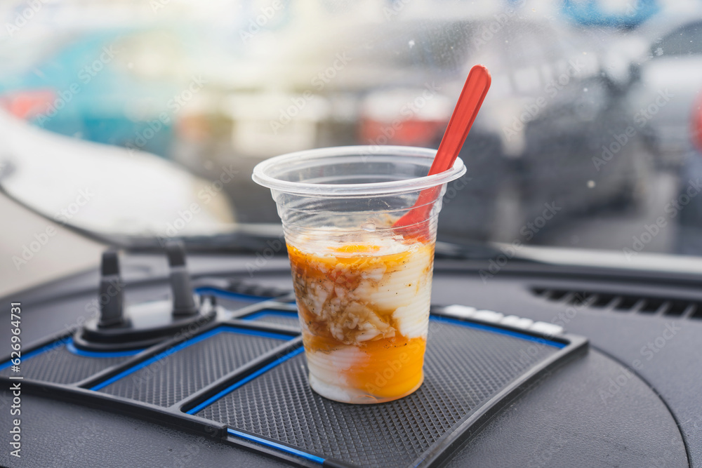 Hard-boiled eggs in plastic cup ready to eat in the car from the shop ...