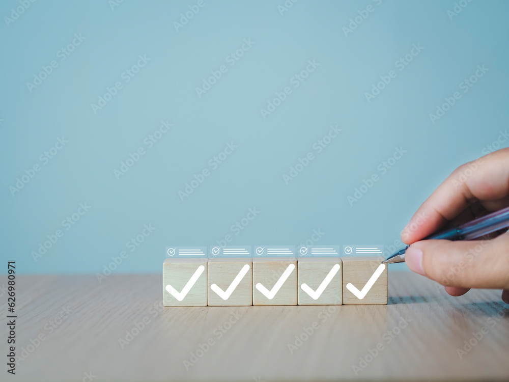 Quality assurance concept Businessman using pen to make correct mark in ...