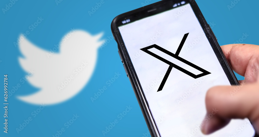 hand holding a mobile phone with the new X logo on the screen Stock ...