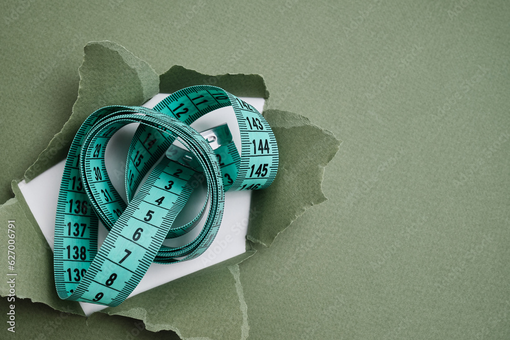 Green measuring tape on a light background. Tool for measuring length ...