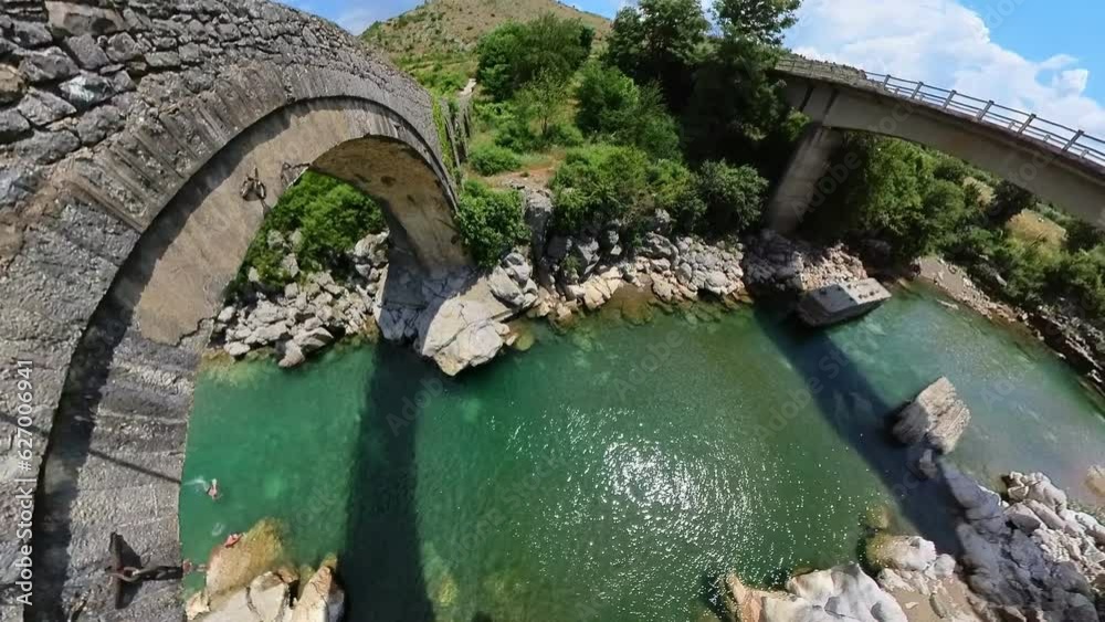 Drone view of the Mesi Bridge, located in Albania, is an architectural ...