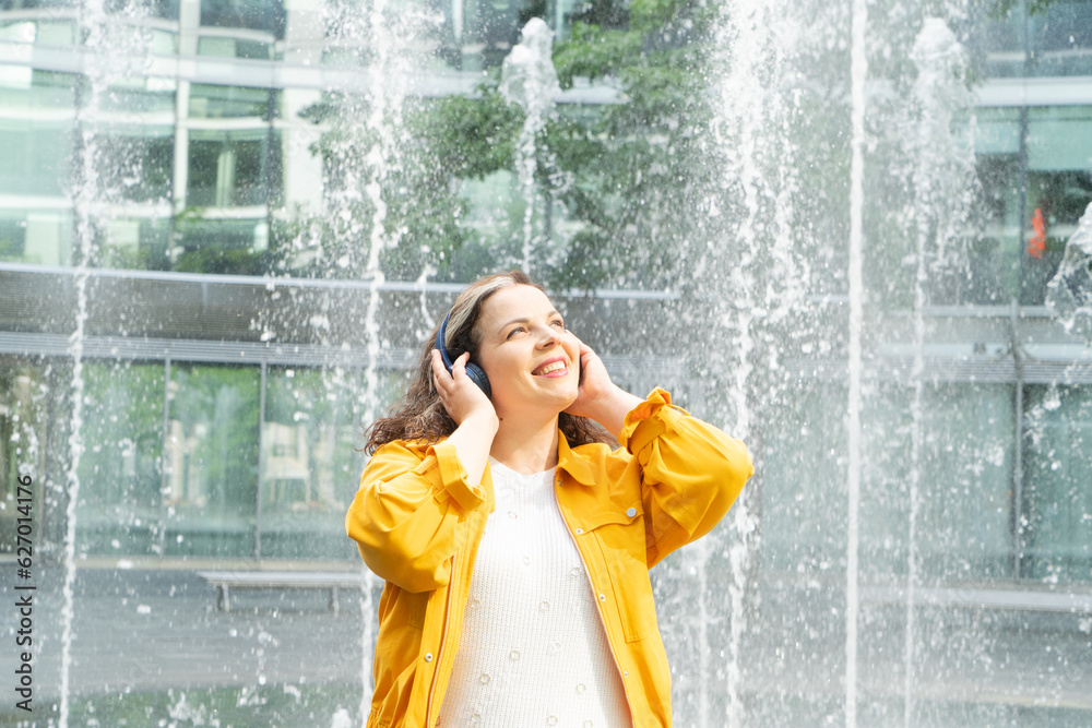 Happy curvy woman in city, plus size brunette lady with curly hair ...