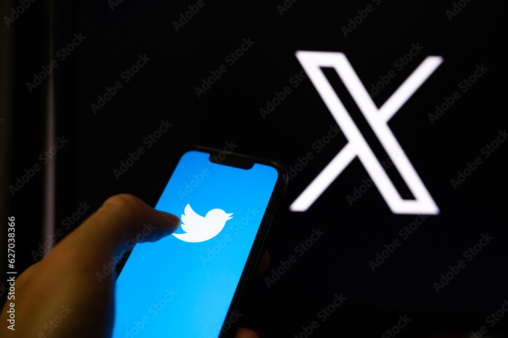 New logo of Twitter. Old and new logo of Twitter. Human hand playing on ...