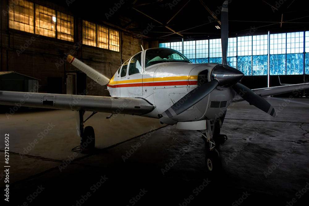 Moody and dramatic aircraft in hanger. Single engine airplane rest in ...