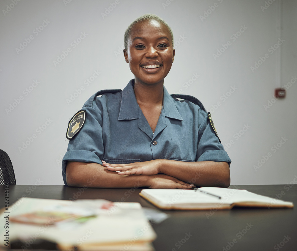 Happy, smile and portrait of a female police officer sitting by a desk ...
