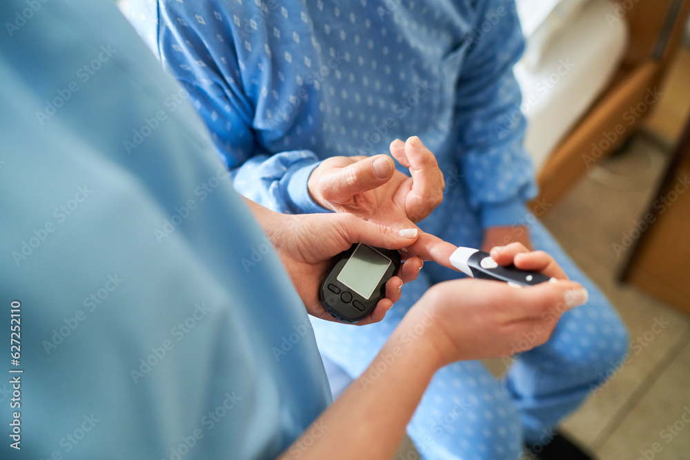 Nurse checking blood sugar of diabetic patient at nursing home Stock ...