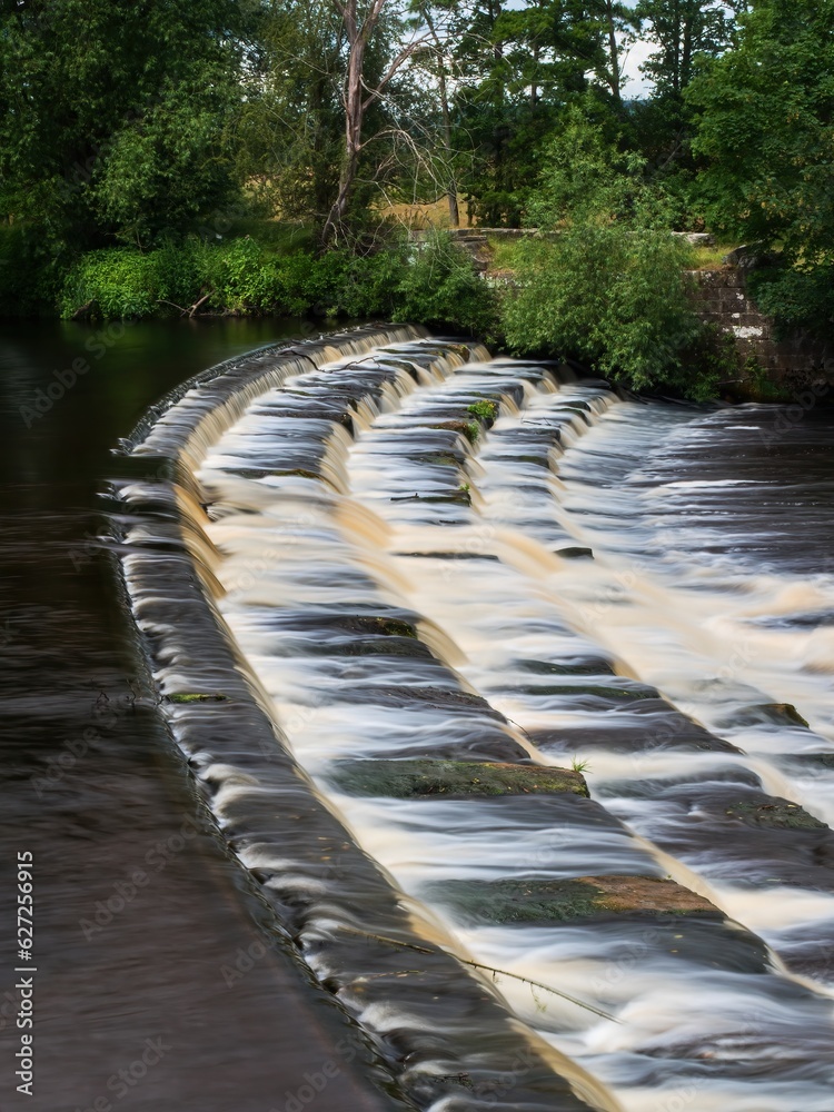 A beautiful weir across the river Wharfe at Burley-in-wharfedale in ...