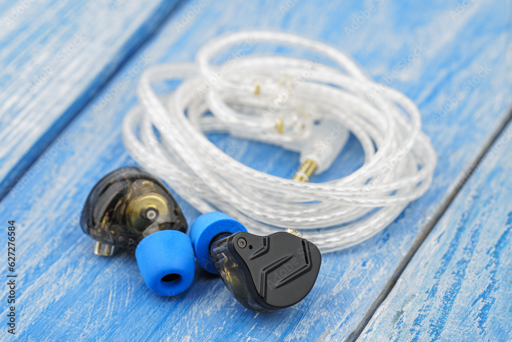 In ear monitor on a tablature background. Custom in-ear monitors with ...