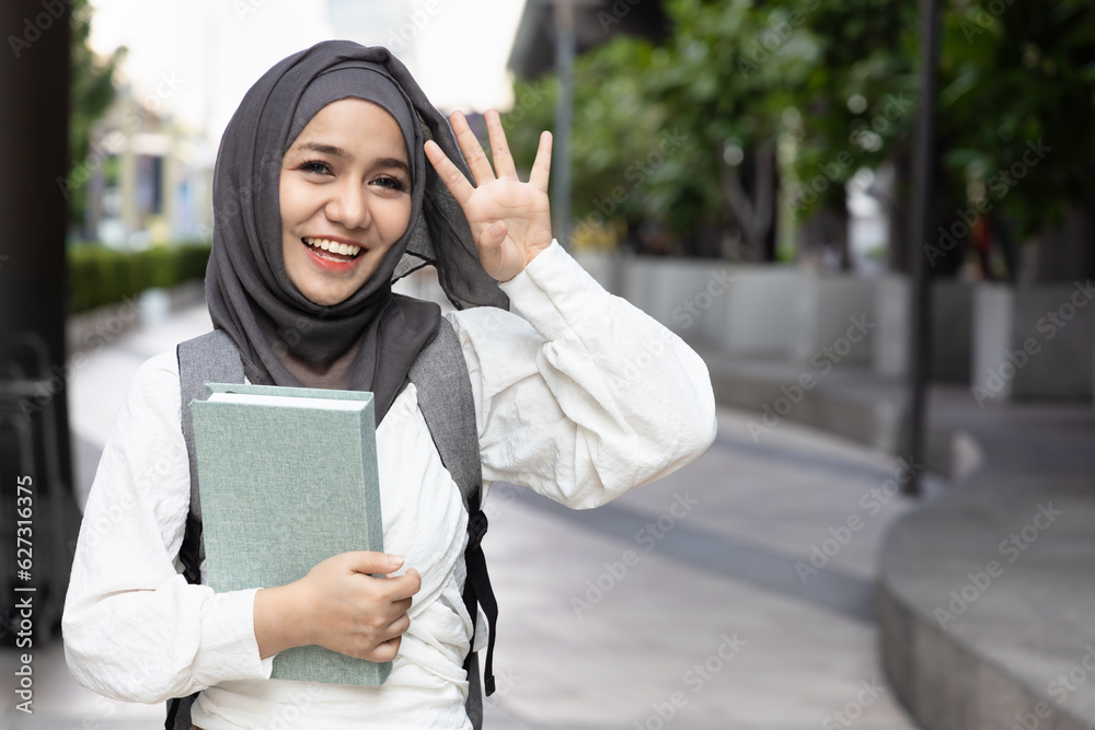 Young Muslim Woman Student pointing up 4 fingers, Back to School ...