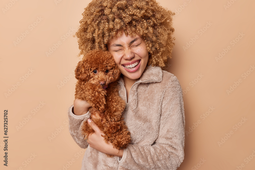 Woman carries her poodle dog with pride radiating joy and warmth ...