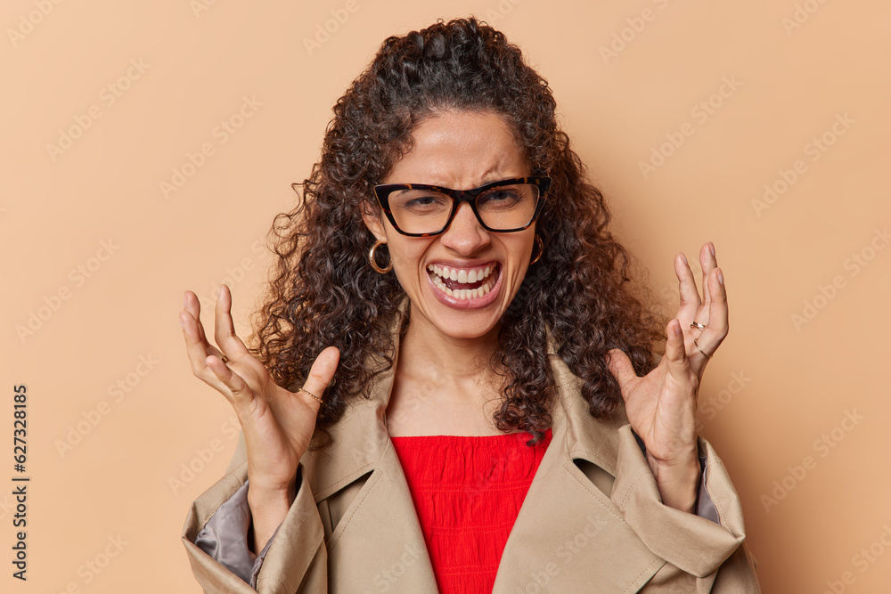 Irritated curly haired Brazilian woman angrily gestures venting ...