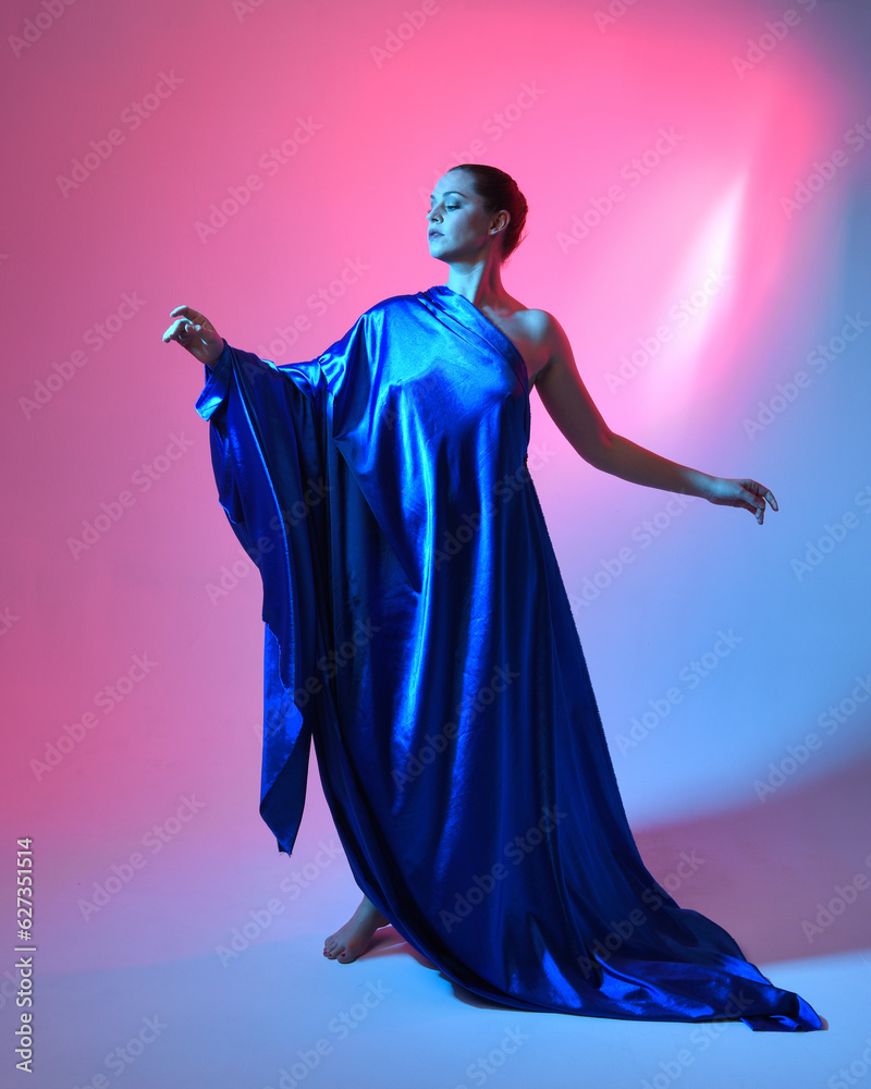 Full length portrait of beautiful female model wearing elegant flowing ...