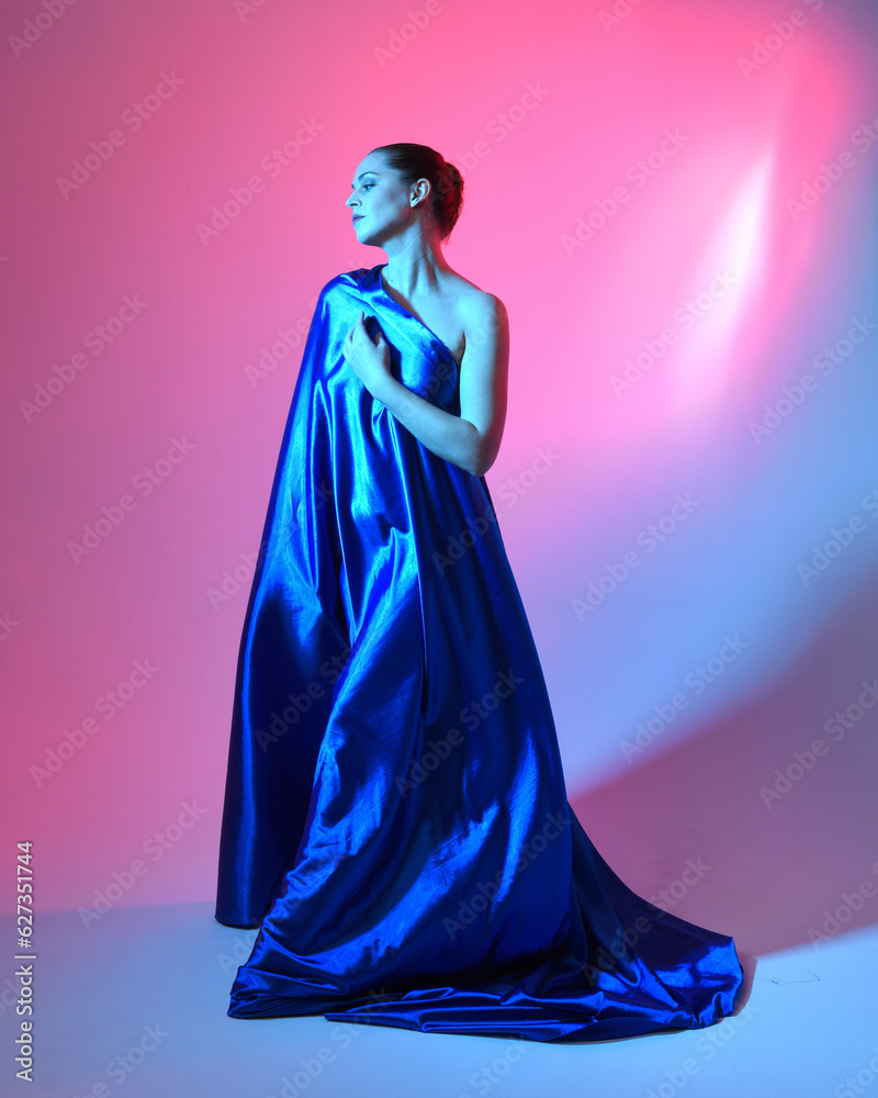 Full length portrait of beautiful female model wearing elegant flowing ...