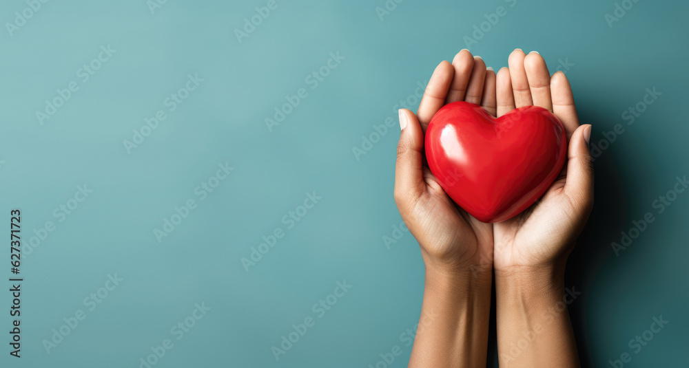 Hand giving red heart , charity symbol Stock Photo | Adobe Stock