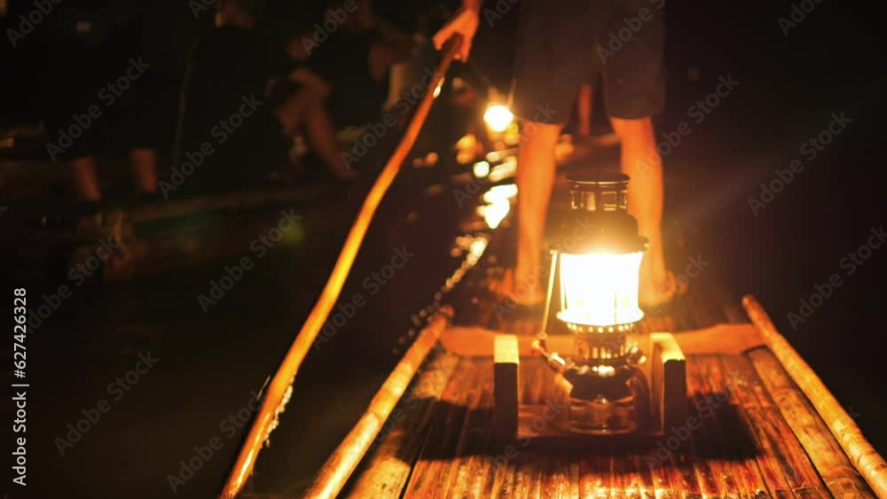 Bamboo raft with a burning lantern floats through natural limestone ...