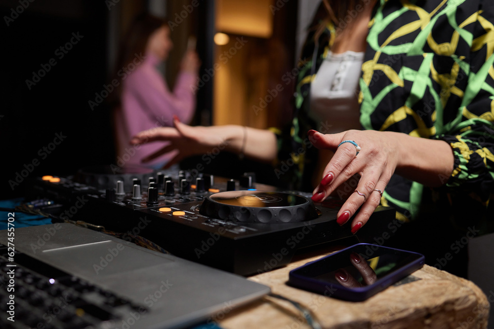 DJ turntable console mixer controlling with two hand in concert ...