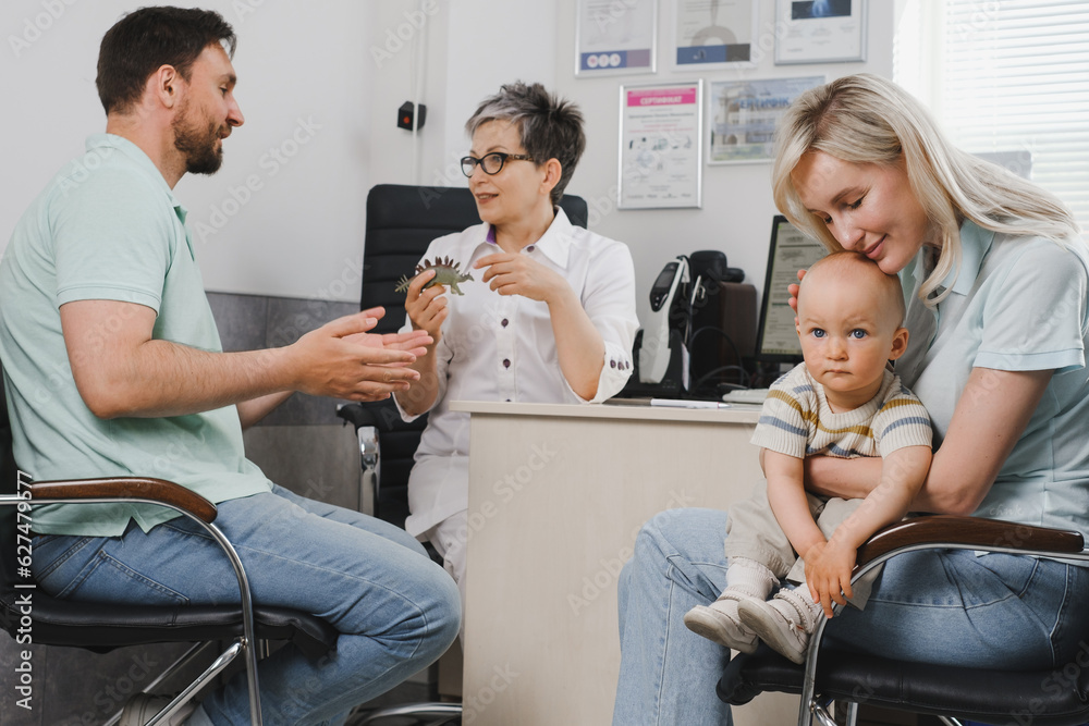 Family at kids hearing check-up. Parents with infant child consulting ...