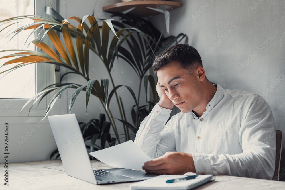 Confused frustrated young man reading letter, debt notification, bad ...