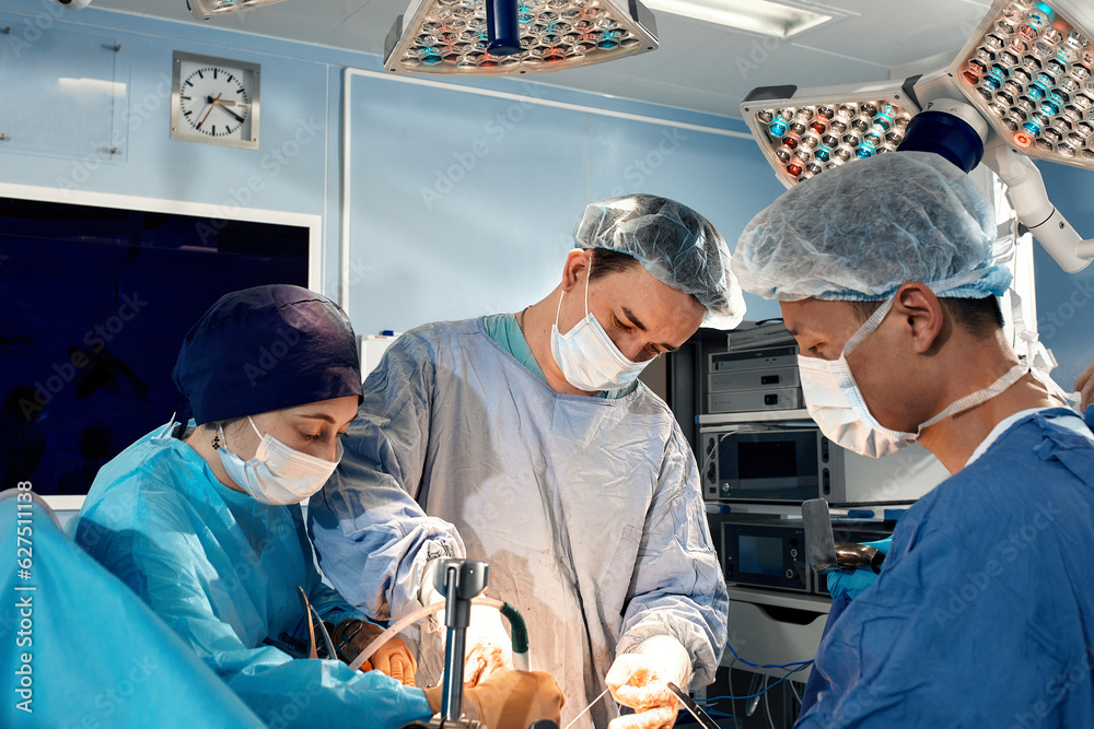 Surgeons team during complex surgical operation in a sterile operating ...