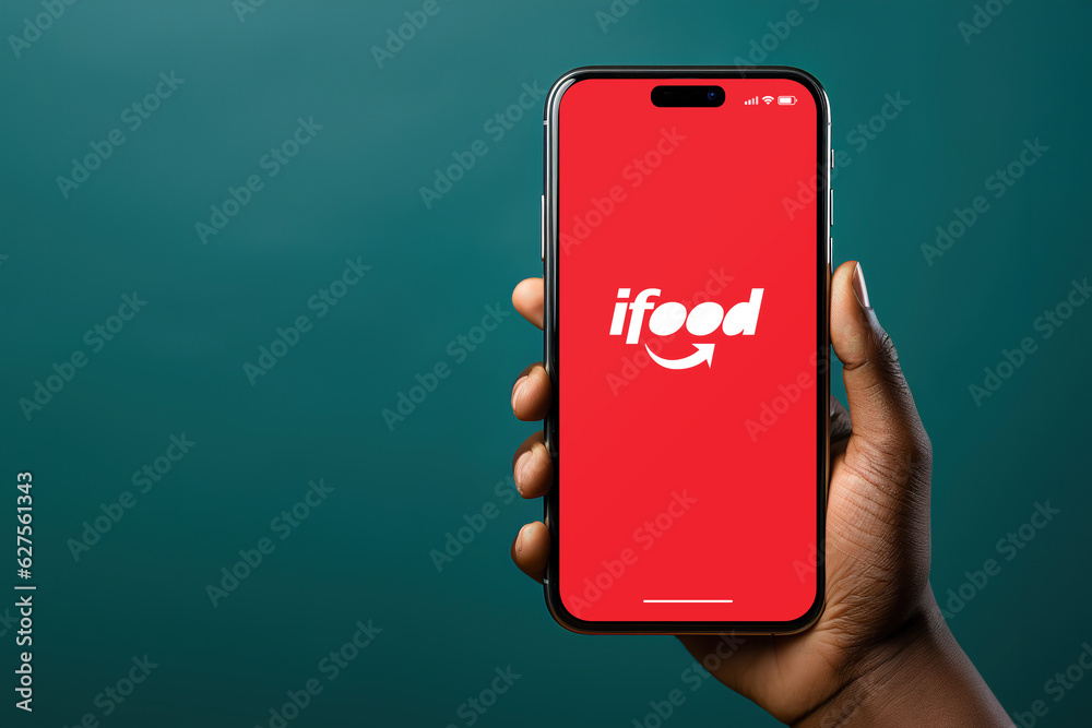 Black hand holding a smartphone iPhone with Ifood delivery app on the ...