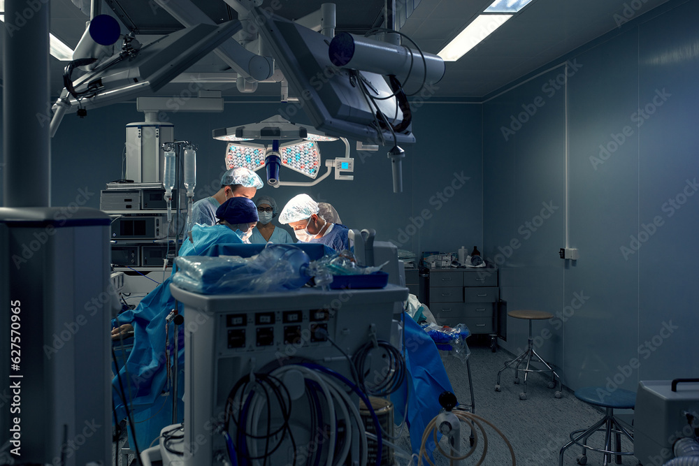Surgeons team during complex surgical operation in a sterile operating ...