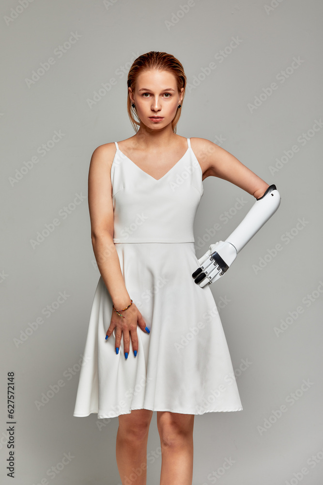 Half-length studio portrait of young girl in white dress wearing ...