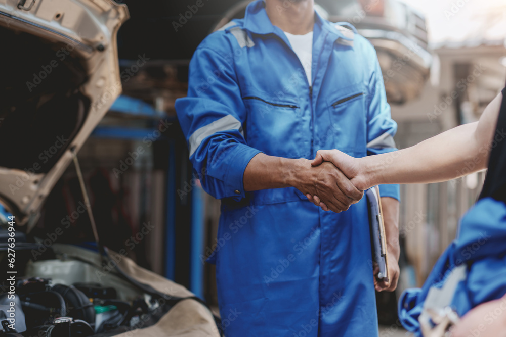 Auto mechanic handshake successful colleague in auto service center To ...