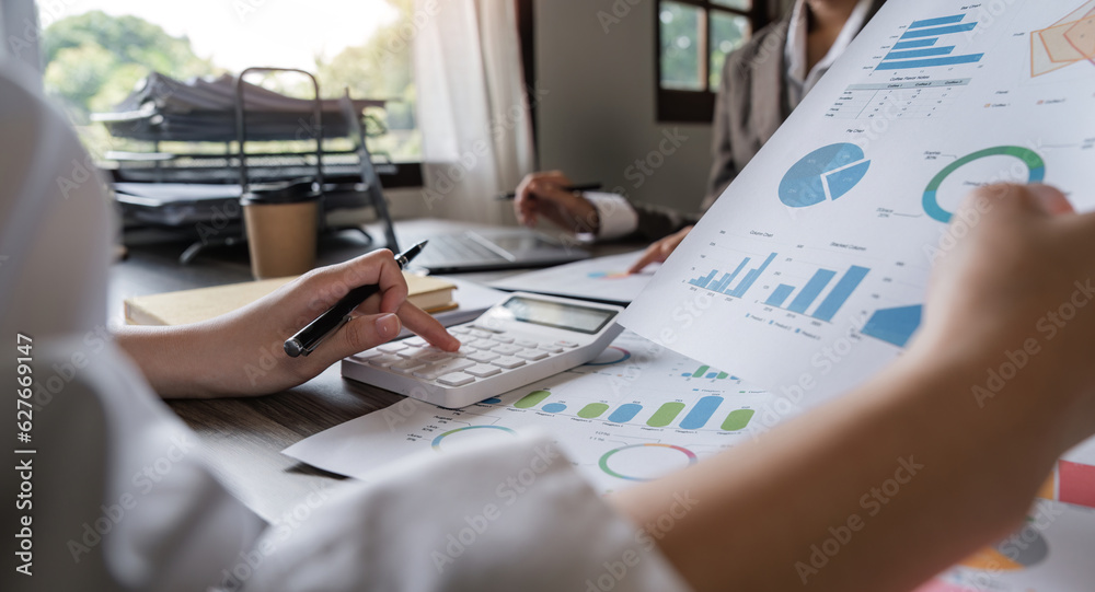 Team work process Business team use calculator to calculate figures ...