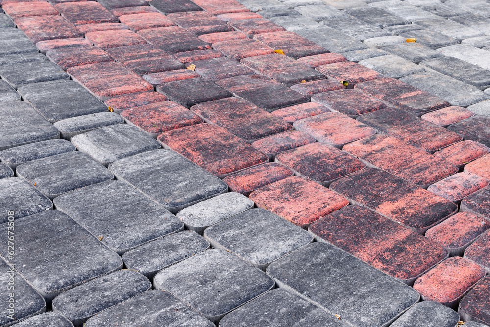 Laying paving slabs of different sizes with rounded corners and uneven ...
